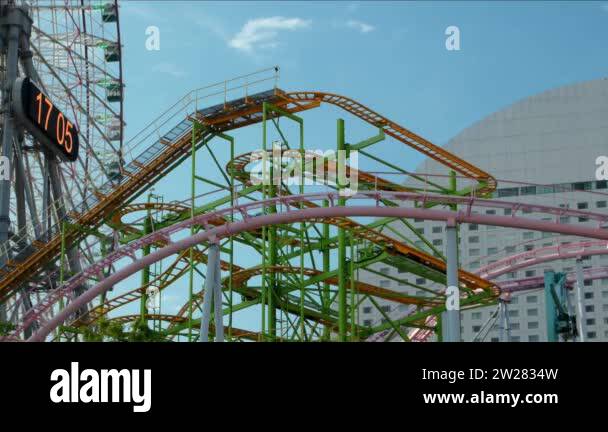 Yokohama - Amusement park attractions with ferris wheel and roller ...