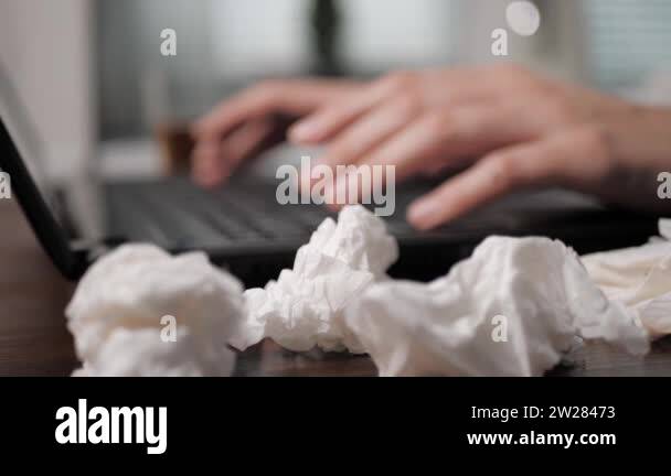 Female hands are typing on keyboard next to dirty paper handkerchiefs ...