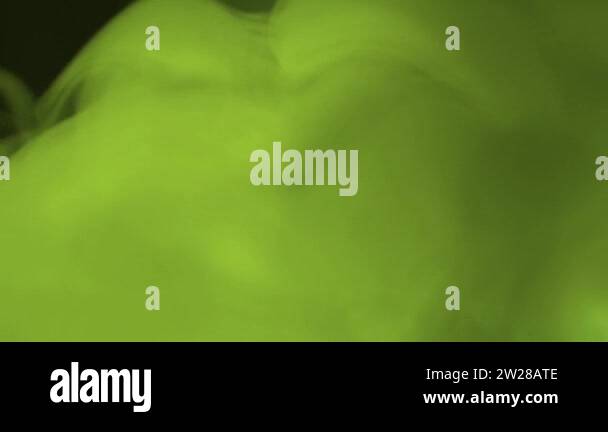 Abstract steam mist of green color on a black background.A gaseous ...