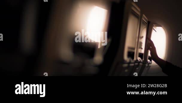 Passenger using airplane entertainment touch screen during the flight ...