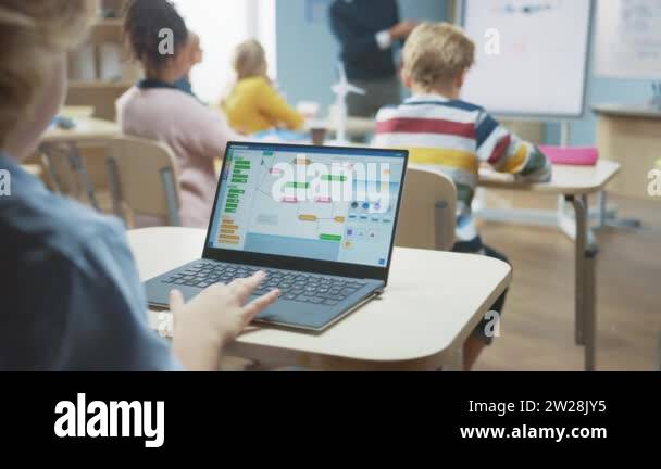 Elementary School Science Class: Over the Shoulder Little Boy Uses ...