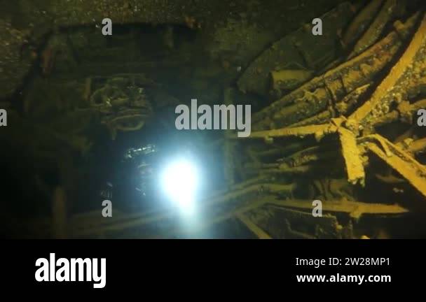Diver on sunken ship inside view on wreck underwater in Truk Lagoon ...