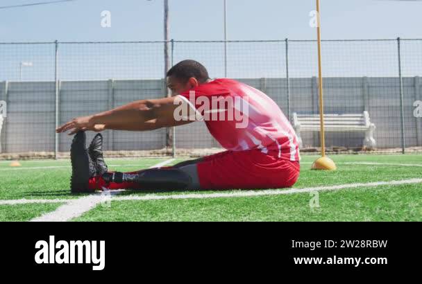 Side view of a mixed race male football player with a prosthetic leg ...