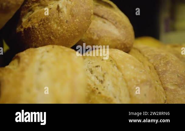 Row of fresh baked loaves of bread lying on the shelf in grocery store ...