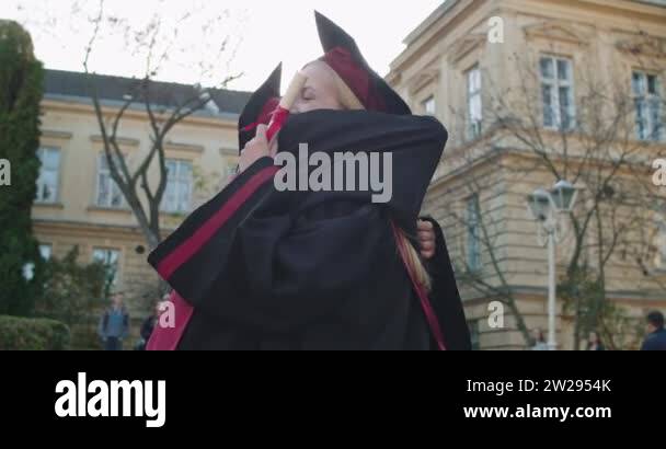 Two mixed-races young pretty girls friends, graduated students hugging ...