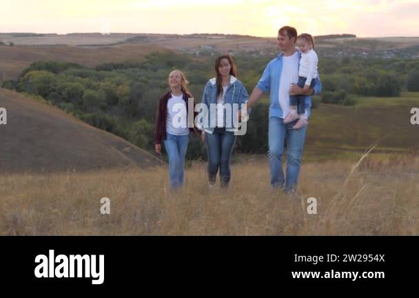 Small children and parents have a rest traveling together holding Riki ...