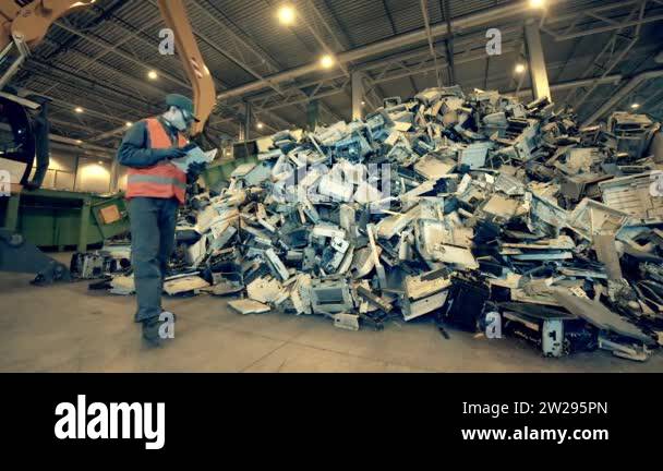Fractions of office machines is being inspected by a male worker ...