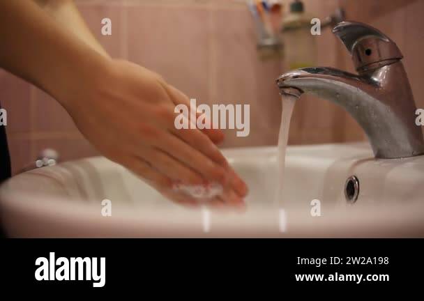 Washing hands with soap and warm water to prevent the coronavirus ...