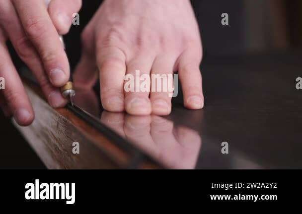 The tanner is cutting black leather sheet with a razor and metre Stock ...
