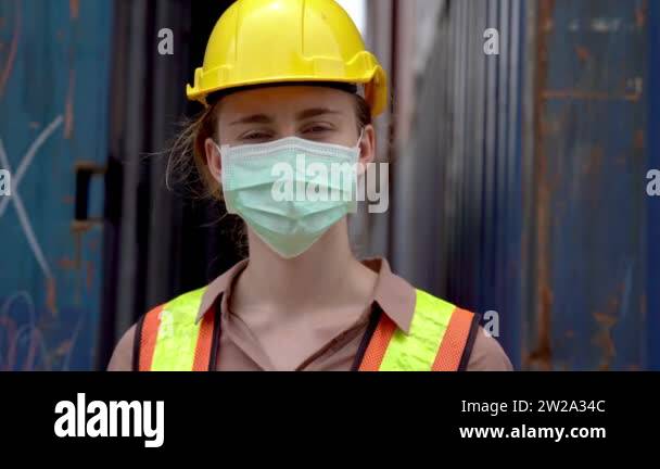 woman worker in mask face and using measures temperature with a non ...