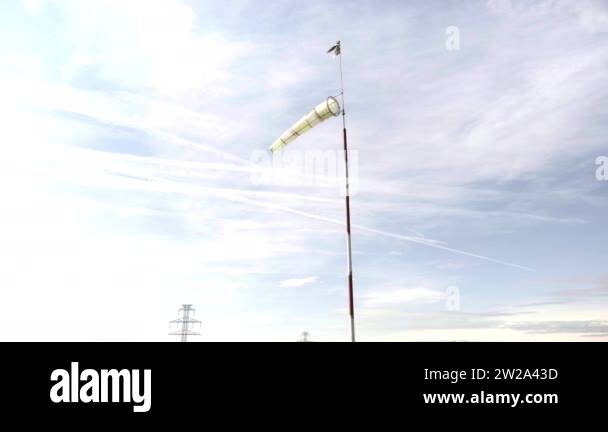 Windsock on sunset sky background. Gauge weather instrument blazing in ...