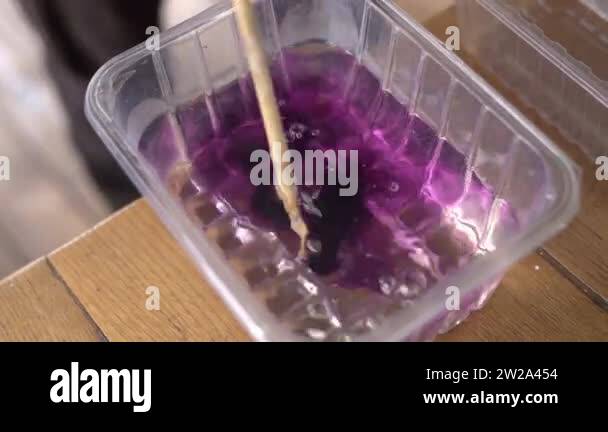 The process of dissolving potassium permanganate in water in a ...