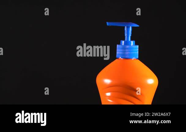 Orange bottle of detergent. Bottle without labels and name. Hand ...