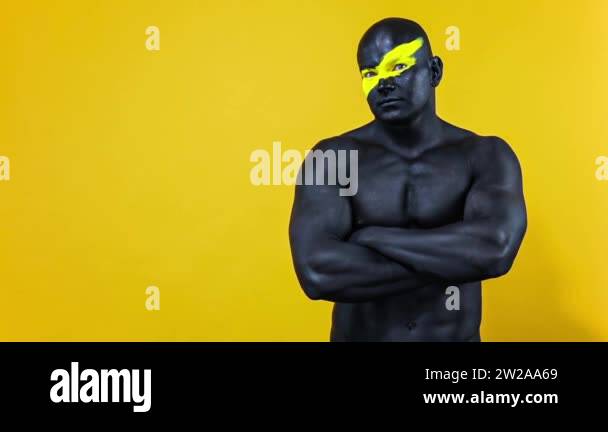 Man sports fan and bodybuilder athlete with yellow color on face art ...