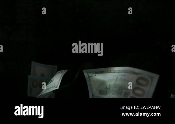 Falling flying american canadian dollar banknotes on a black background ...