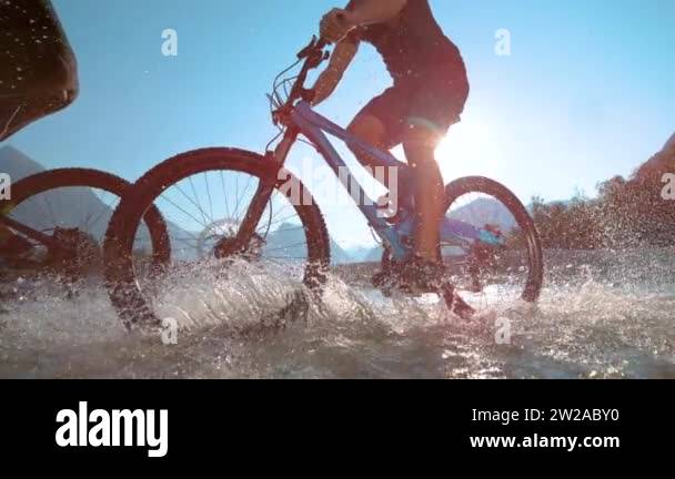 LENS FLARE: Blinding sun rays shine on friends riding bicycles in ...