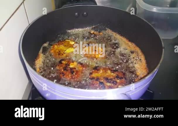 Chapli Kebab frying in the oil, a closeup view. Chapli kabab are ...