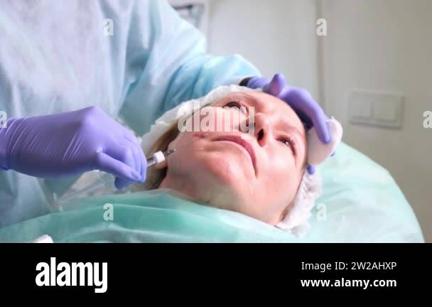 Middle aged woman 50 getting a lifting injection of an injection of ...