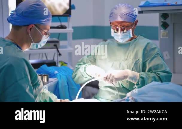 Team operating in surgical room. Medical team performing surgical ...