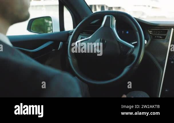 Self Driving Autopilot Autonomous Cars. Male driver parking a car which ...
