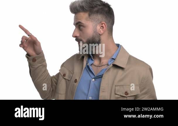 confused young guy pointing fingers and giving directions, scratching ...