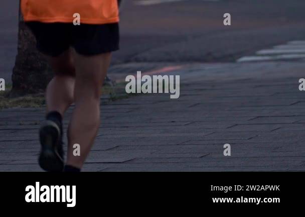Slow Motion of asian man running on the street of Taipei city at nigth ...