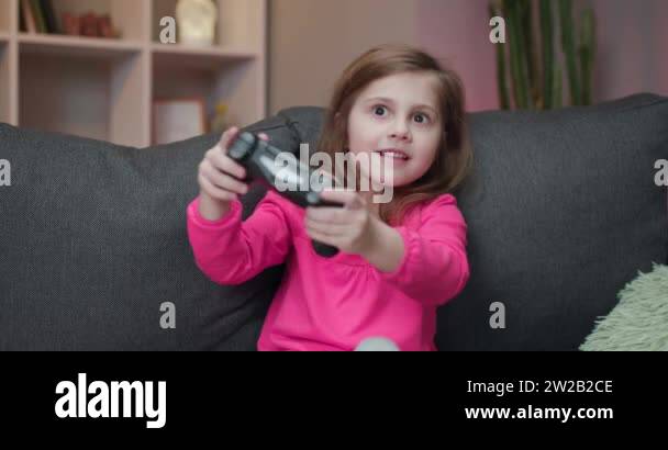Little Girl Playing in Video Game Console Using Joystick Controller ...