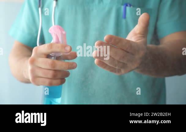 Doctor spray disinfectant on his hands. Medic squirting on arm ...