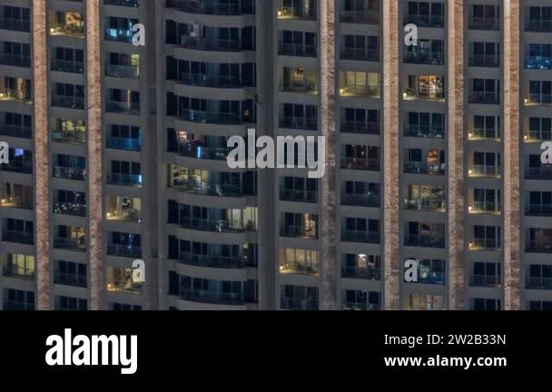 Night view of exterior apartment tower timelapse. High rise skyscraper ...