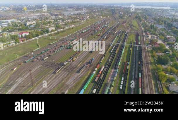 Industrial railway junction in sunny weather. Flying over freight ...