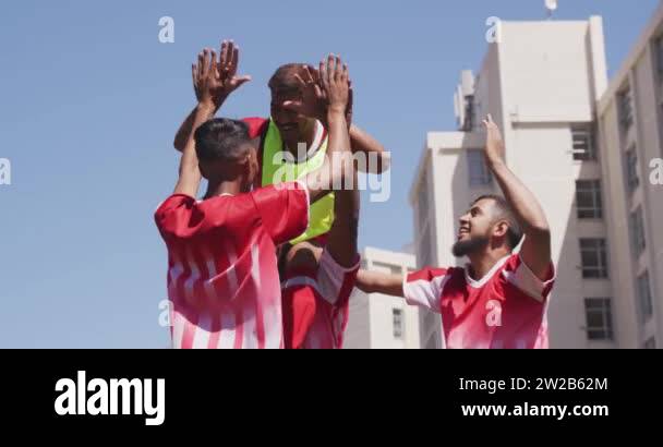 Low angle front view of a multi-ethnic group of male football players ...