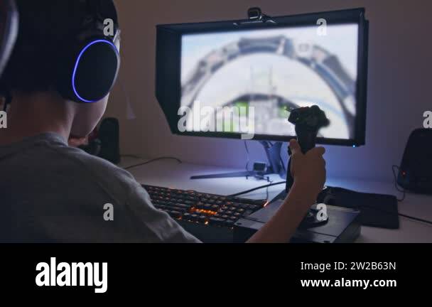 Young boy playing a flight simulator wearing a headset Stock Video ...