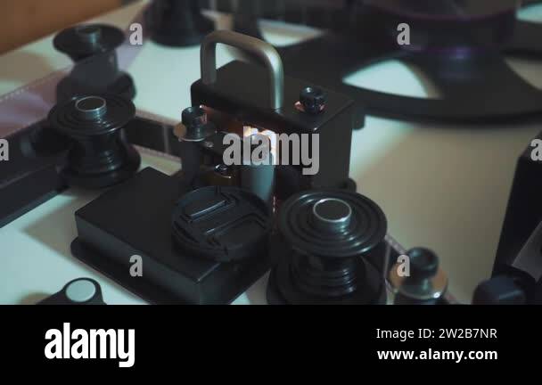 Old movie film strip. scanner is scanning 35 mm film to digital close ...