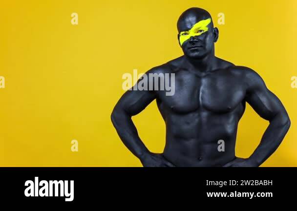 Man sports fan and bodybuilder athlete with yellow color on face art ...