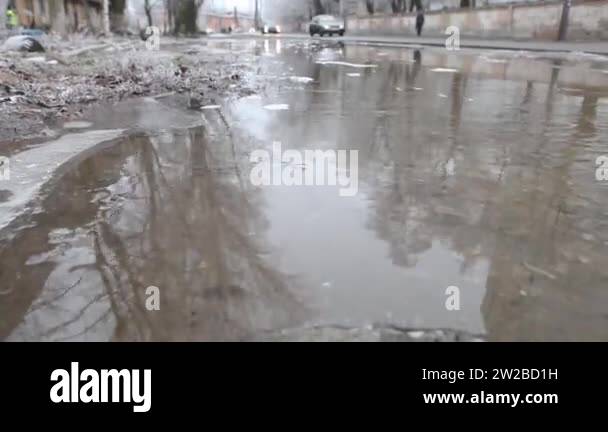 Car traffic on the flooded city street during heavy rain, heavy ...