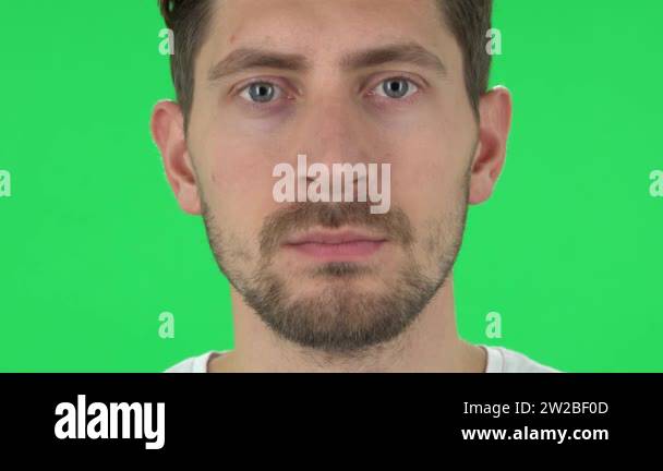 Man with a beard is looking straight. Close up. Green screen Stock ...