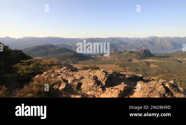 Young man reaching the mountain summit discovering aerial landscape of ...