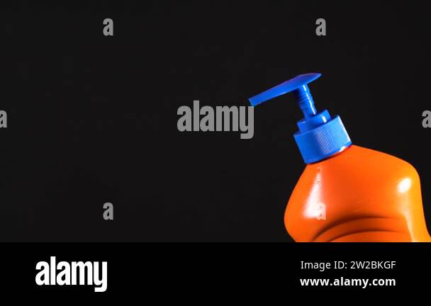 Orange bottle of detergent. Bottle without labels and name. Hand ...