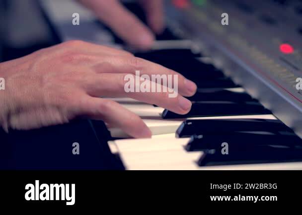 Synthesizer Keyboard. Fingers close on piano keys. Men's hands play ...