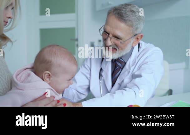 Scared baby crying at health check-up in clinic, visit to family doctor ...