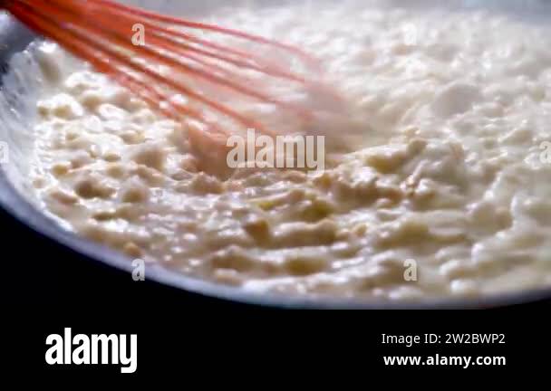 Preparation of traditional bechamel for homemade meat croquettes: milk ...