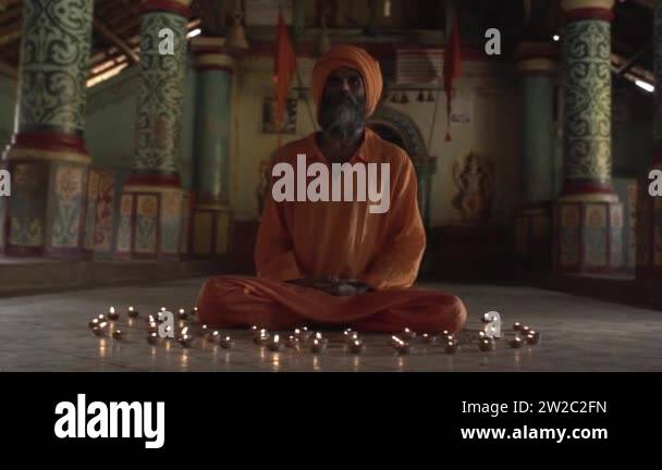 A monk in an ancient temple lights a sacred fire, the priestess brought ...