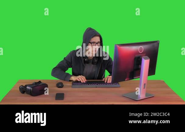 Hacker Typing At computer quickly on a Green Screen, Chroma Key Stock ...