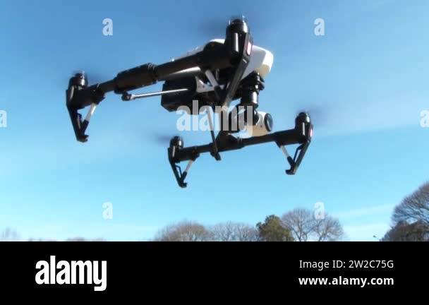 Large, professional unmanned aerial vehicle also known as a quadcopter ...