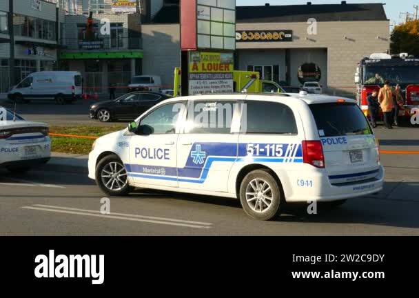 Police officer coming out of van car at crime scene with body in ...