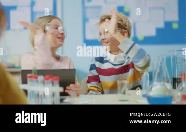 Elementary School Science Classroom: Smart Girl and Clever Boy in ...