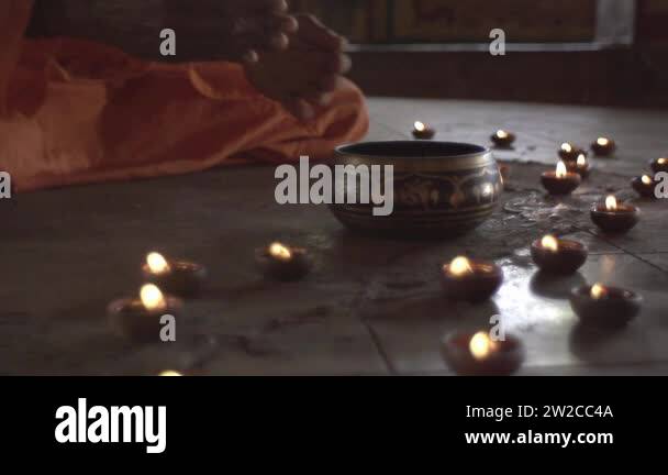 A monk in an ancient temple lights a sacred fire, the priestess brought ...