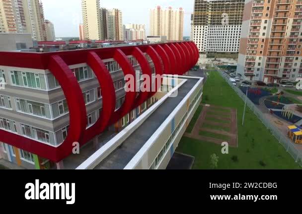 Exterior modern school with elements of red, in a modern residential complex Stock Video Footage ...
