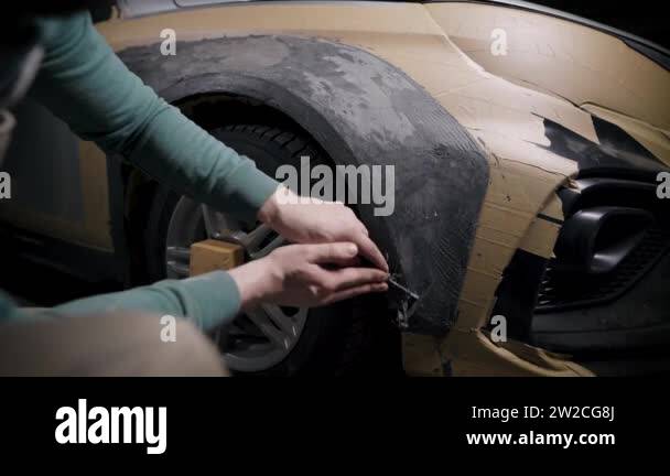 The man works in a tuning studio. Car tuning. The building of the cars ...