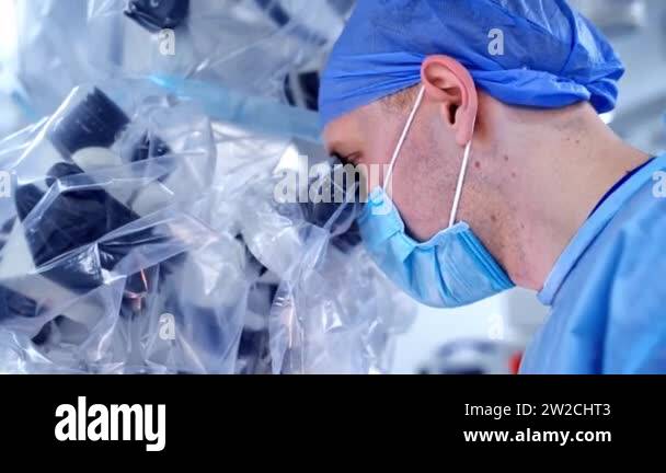 Surgeon Using Operating Microscope. Doctor working inside the modern ...